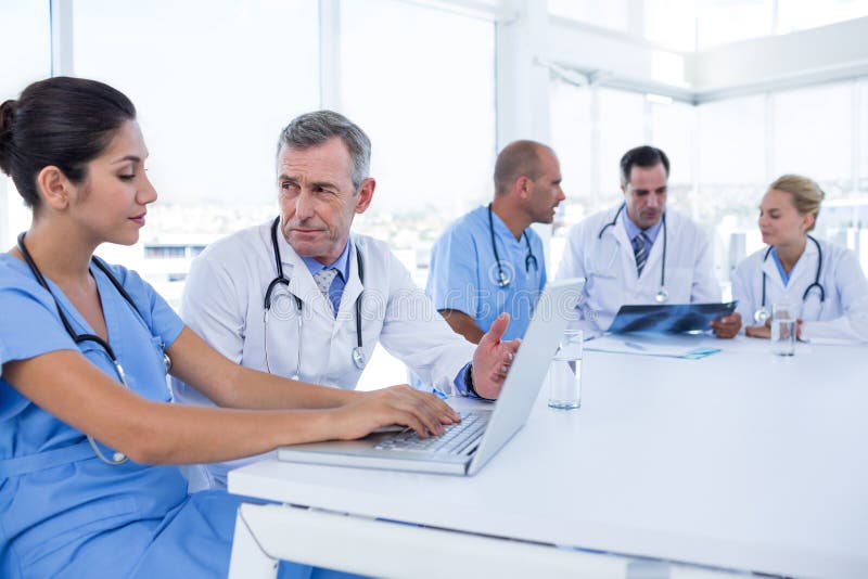 Doctors Using Computer Whiles Theirs Colleagues Looking at Xray Stock ...