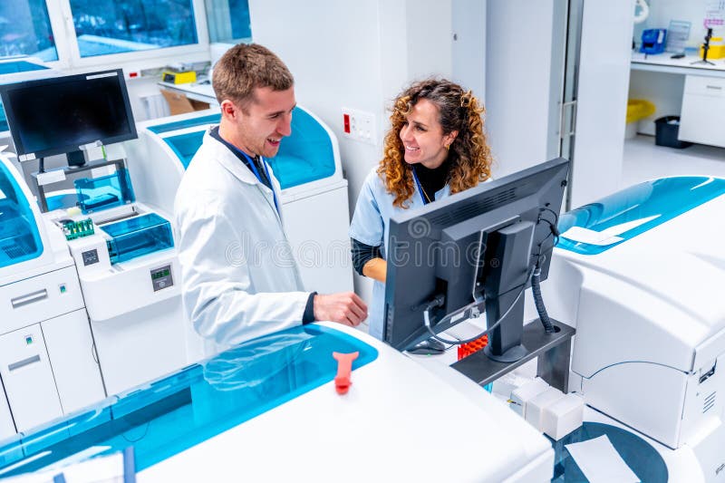 Doctors Using Computer Working in a Laboratory in the Hospital Stock ...