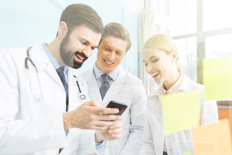 Doctors using smartphone stock photo. Image of medicare - 93464258