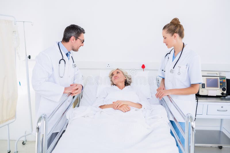 Doctors Visiting a Female Patient in Hospital Stock Photo - Image of ...
