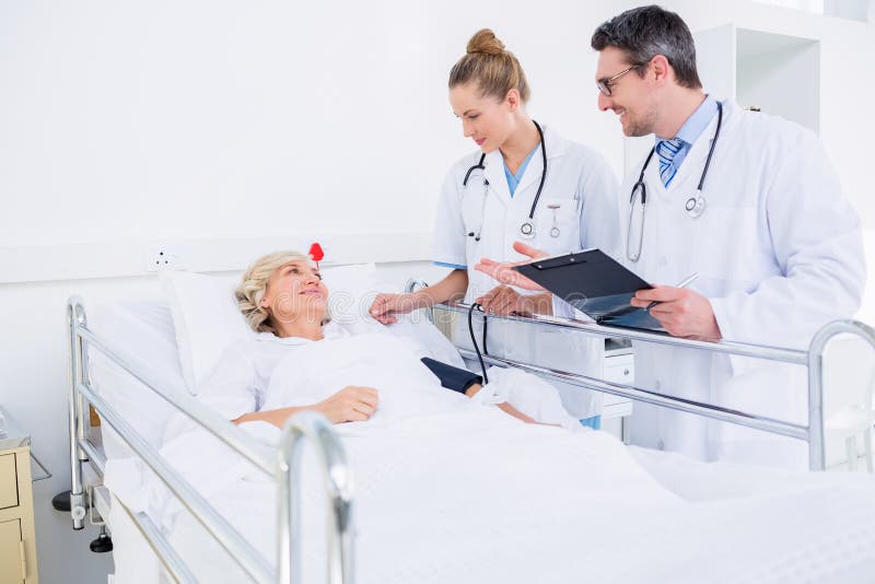 Doctors Visiting a Female Patient in Hospital Stock Image - Image of ...