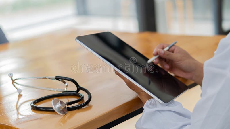 Doctors Work with Tablets in the Office and Headphones on the Table ...