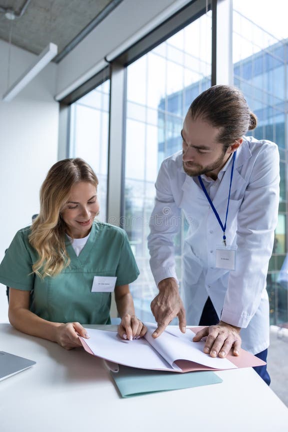 Doctors Working on PC Analyzing Research Data Talking with Colleagues ...