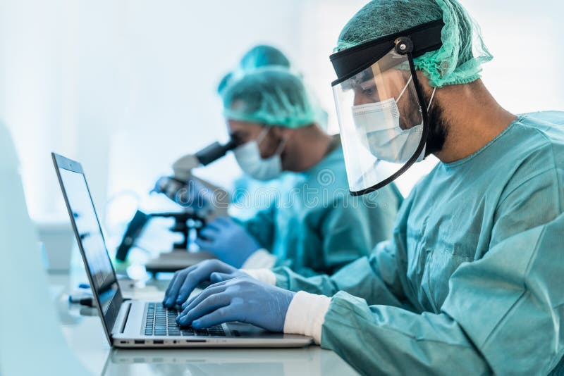 Doctors Working in Research Laboratory Using Computer and Examining ...