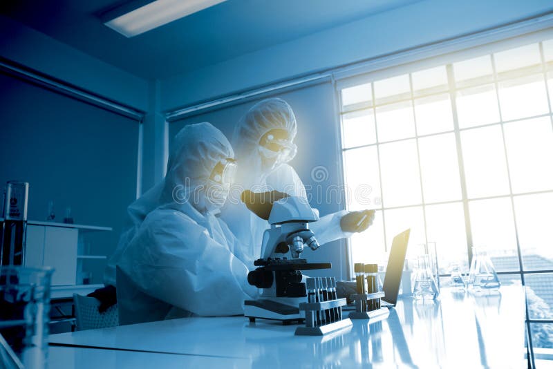 Doctors Working in Virus Lab. Doctor Using Microscope Check for Viruses ...