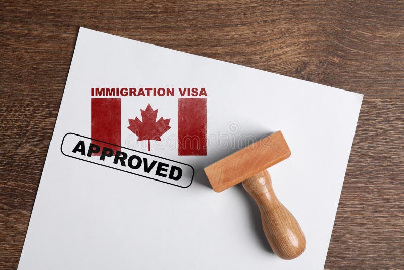 Document with Approved Immigration Visa in Canada and Stamp on Wooden ...
