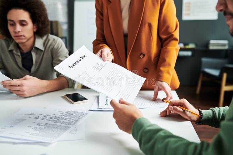 Document with English Grammar Test Being Passed by Teacher Stock Photo ...