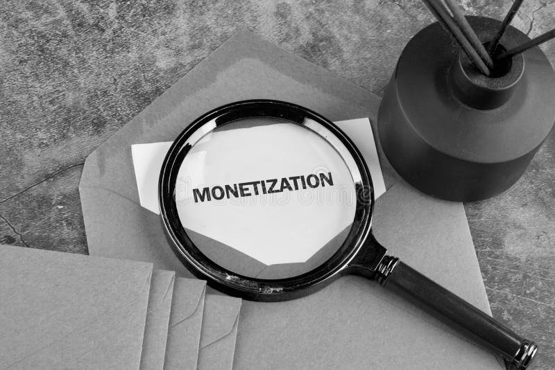 A Document Labeled Monetization is Examined Closely with a Magnifying ...