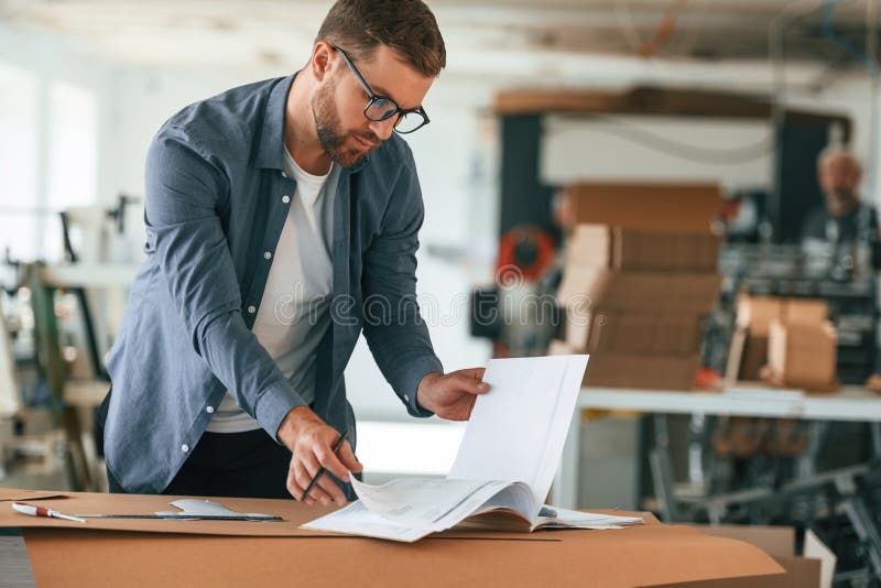 Document on the Table. Handsome Man is Working at the Factory of ...