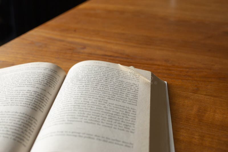 A Dog Eared Page in a Paperback on Table Stock Image - Image of reading ...