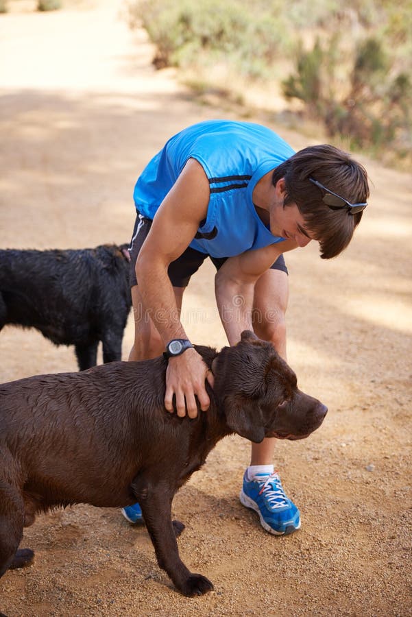 Dogs Need Their Exercise Too. a Young Man Exercising Outdoors with His ...