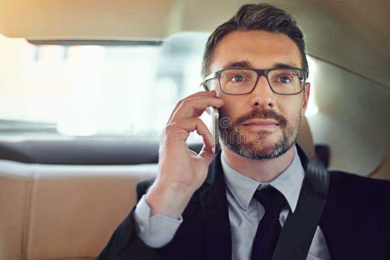 Doing Business while on the Move. a Businessman Using His Cellphone ...
