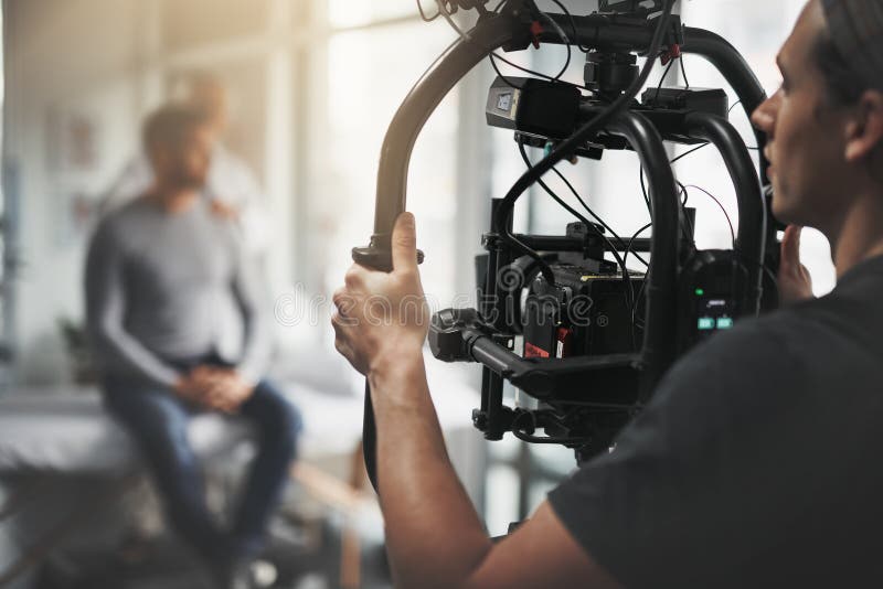 Doing it Cinematic Style. Behind the Scenes Shot of a Camera Operator ...