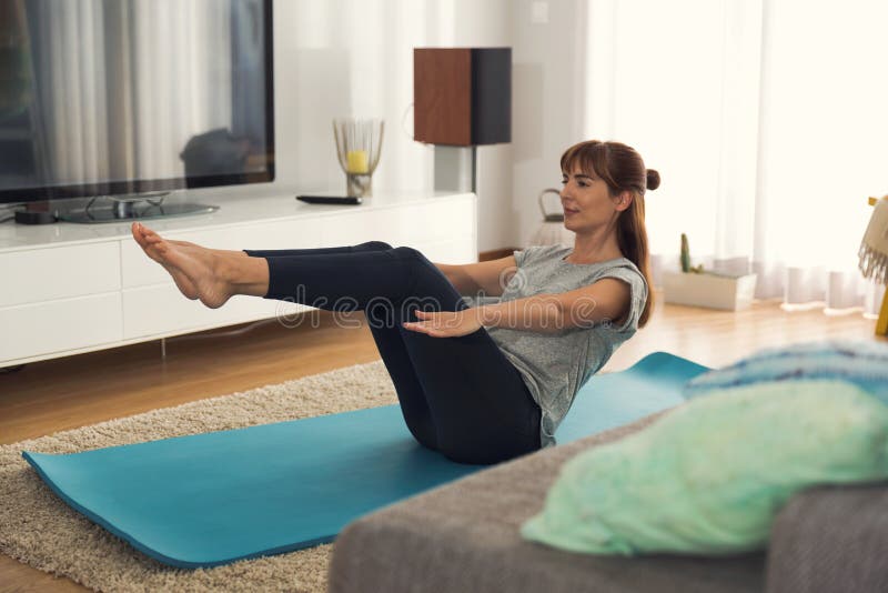 Doing exercise at home stock image. Image of pilates - 105347719