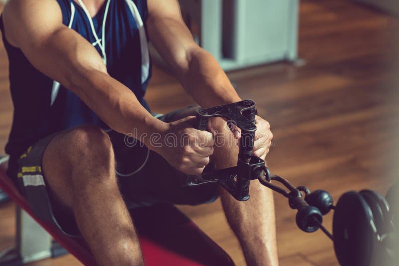 Doing Exercise on Rowing Machine Stock Image - Image of muscular ...