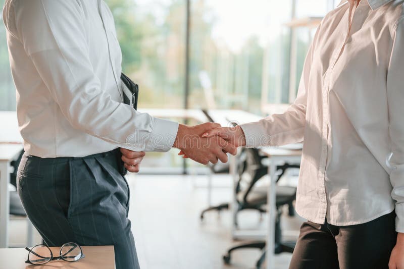 Doing Handshake. Man and Woman are Working in the Modern Office ...