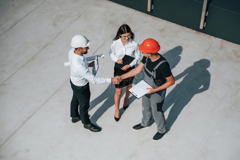 Doing Handshake. Top View of Men and Woman that are on Construction ...