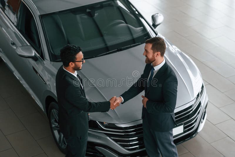 Doing Handshake. Two Businessmen are Working Together in the Car ...