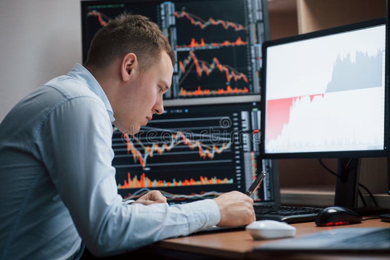 Doing His daily Job. Man Working Online in the Office with Multiple ...