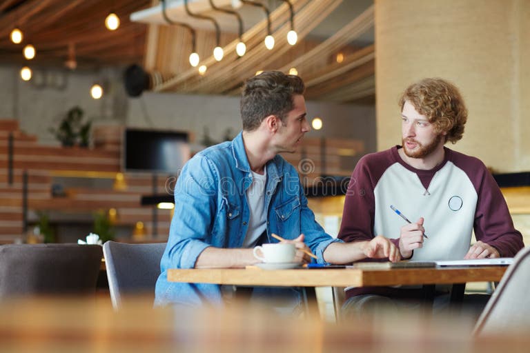Doing homework in cafe stock image. Image of discussing - 99262511