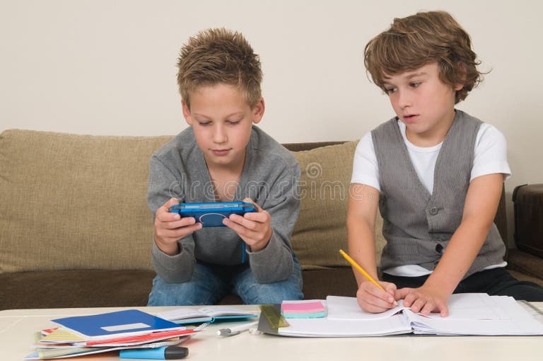 Doing Homework while Gaming Stock Photo - Image of jealous, gaming ...