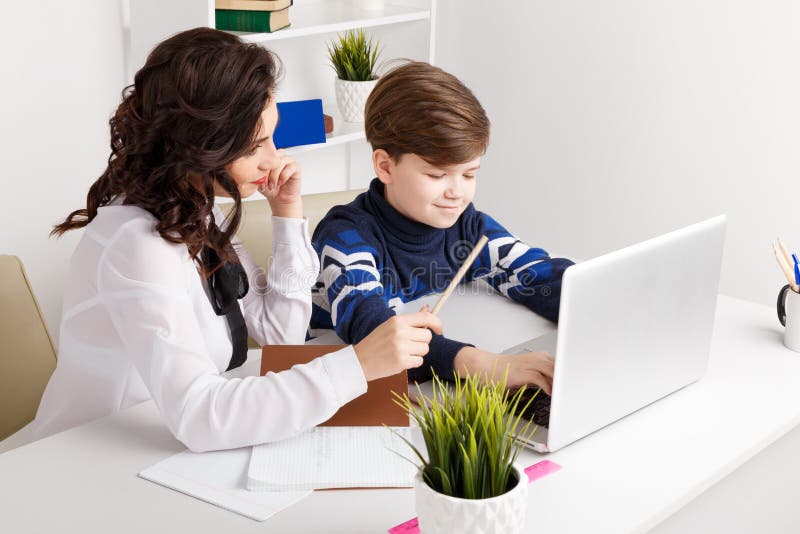 Doing Homework on the Laptop. Child Doing Homework and His Teacher ...