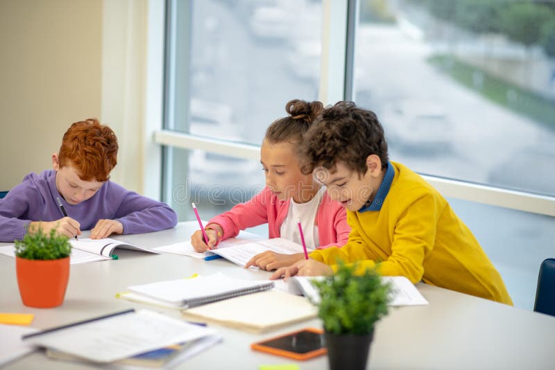 Three Pupils Working on Their Assignment Together Stock Photo - Image ...