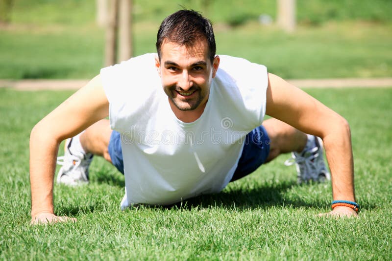 Doing push-ups at the park stock photo. Image of adults - 71326440