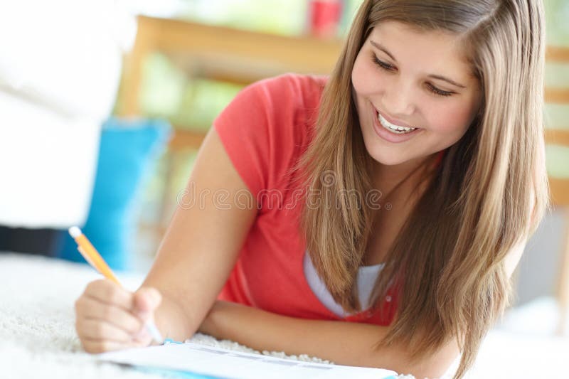 Doing Some College Work. a Pretty Student Doing Homework while Lying on ...