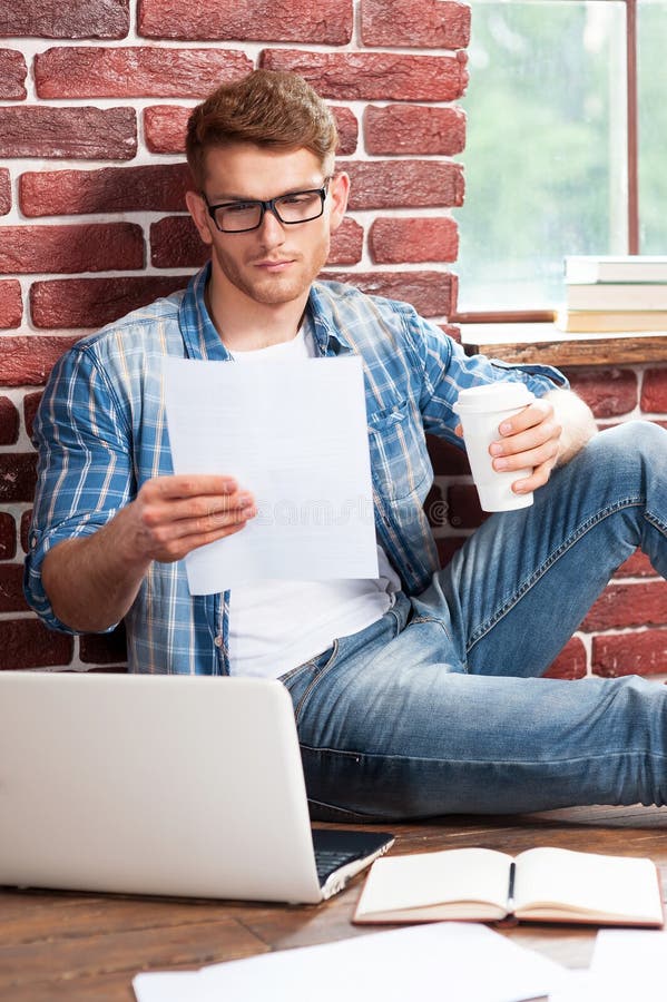 Man examining documents. stock image. Image of examining - 63391399
