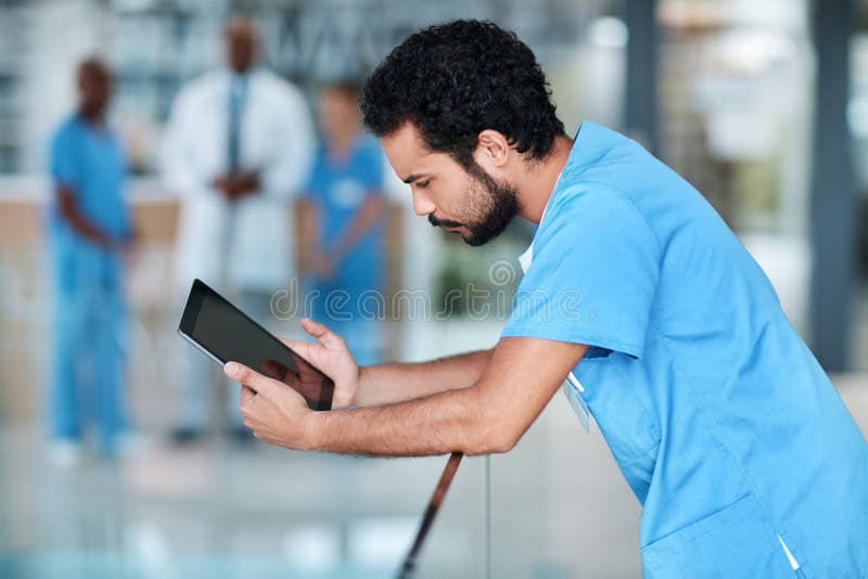 Doing Some Research on His Break. a Young Medical Practitioner Using a ...