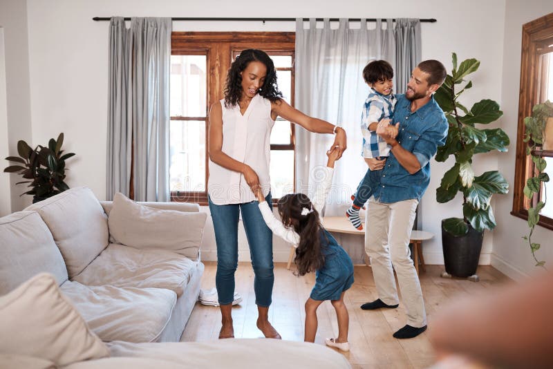 Doing Their Happy Dance. a Family of Four Dancing Together at Home ...