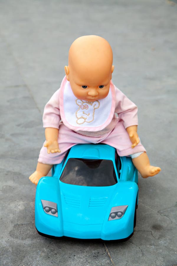 The Doll Sitting on Toy Sport Car Stock Photo - Image of land ...