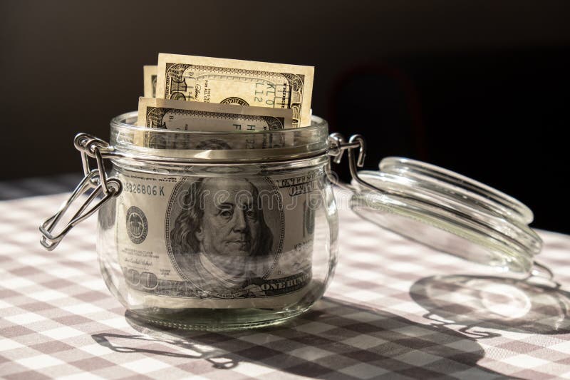 Dollar Banknote Saving Money in Glass Jar. Consumption and Economy ... Dollar Banknote Saving Money in Glass Jar. Consumption and Economy ...