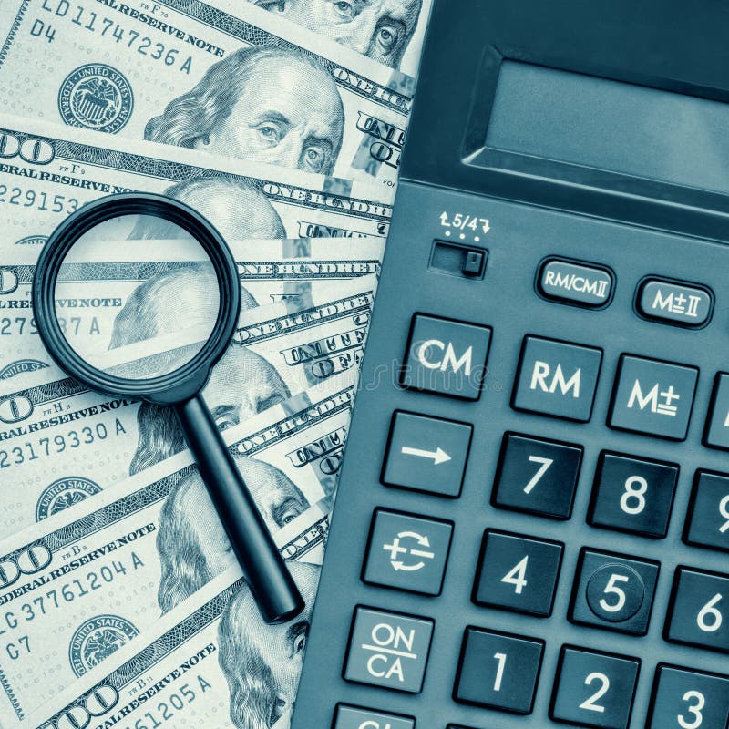 Dollar Bills with a Calculator and a Magnifying Glass Stock Photo ...