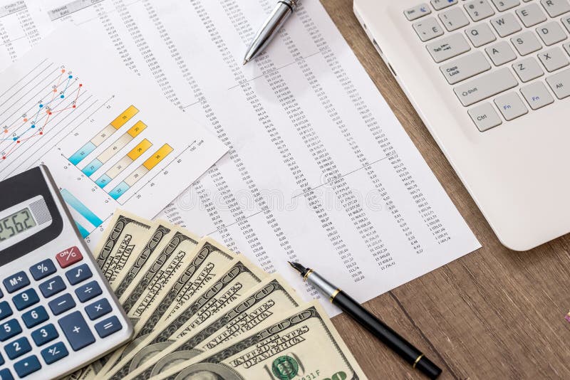Dollar Bills on a Table with Graph Chart and Laptop, Pen Stock Image ...