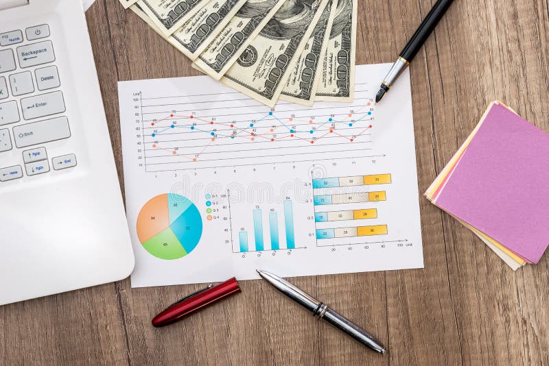 Dollar Bills on a Table with Graph Chart and Laptop, Pen Stock Image ...