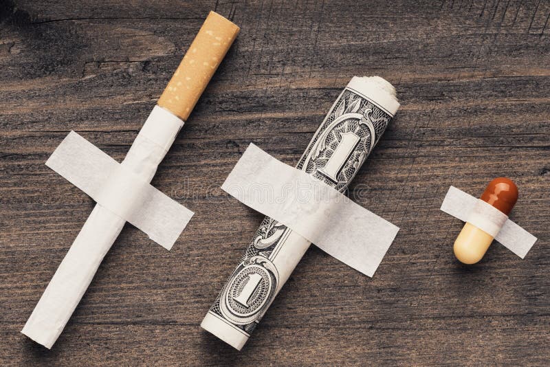 A Dollar Cigarette and a Medical Pill are Fixed on an Adhesive Tape ...