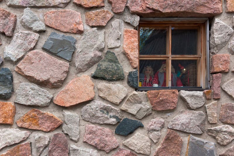 Dolls of Santa Claus Outside Window of Stone House Stock Photo - Image ...