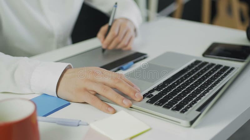 Dolly Shot of Graphic Designer Using Graphics Tablet while Working on a ...