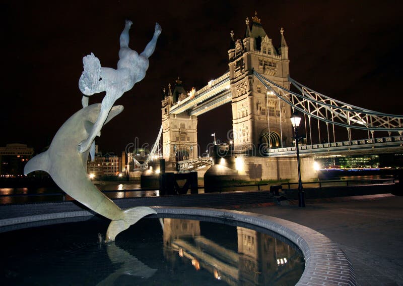 Dolphin Statue and Tower Bridge, at Night London. Stock Image - Image ...