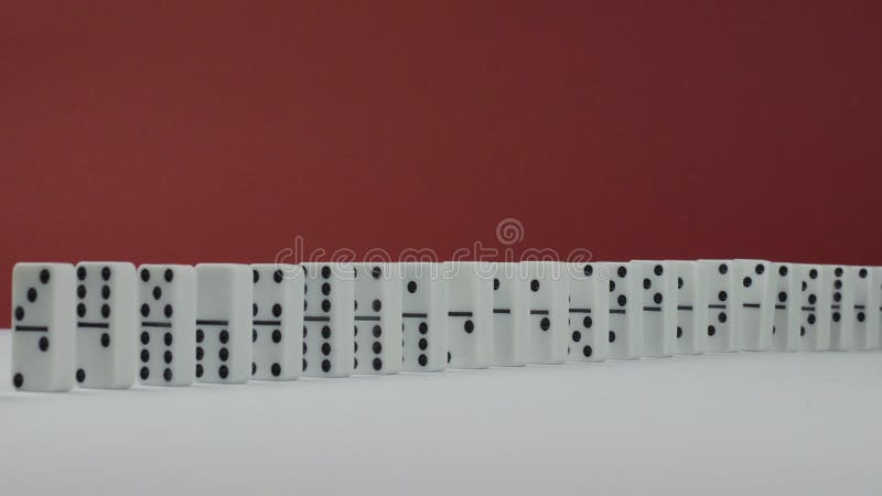 Domino Effect - a Series of Dominoes Falling Down the Chain on Red ...