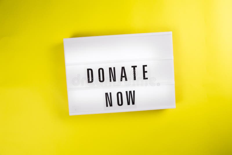 Donate Now Text on Lightbox on Yellow Background Isolated Top View ...