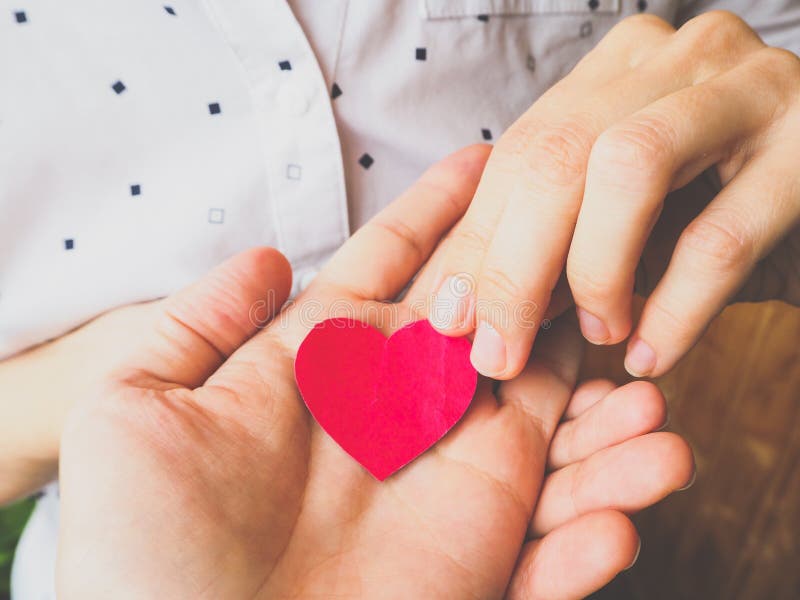 Donated Heart. Large and Small Red Heart in His Hand. Stock Image ...