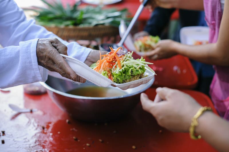 Donating Food from the Concern of Human Friends To the Poor Stock Photo ...