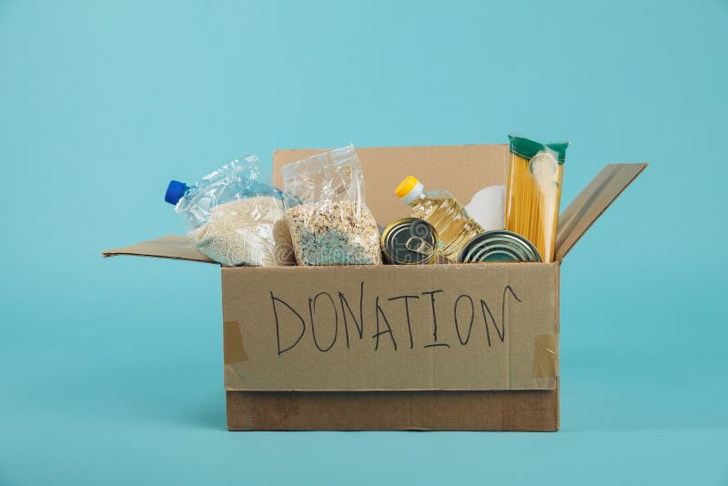 Donation Box. Open Cardboard Box with Clothes and Food on a Blue ...