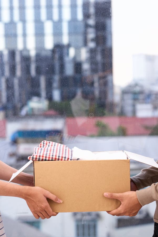 Donation Concept. Donate Box with Clothes in Family Members Hand Stock ...