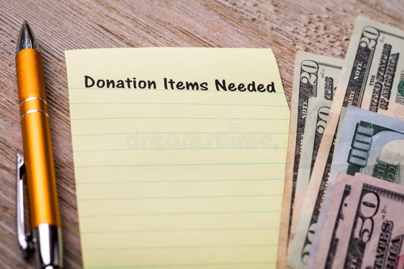 Donation Items Needed Concept on Notebook and Wooden Board Stock Image ...