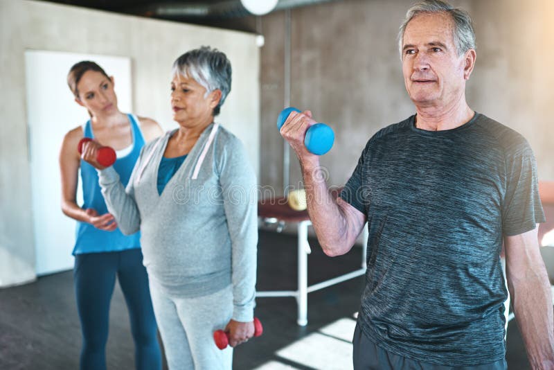 Dont Let Age Define Your Strength. a Senior Man and Woman Using Weights ...