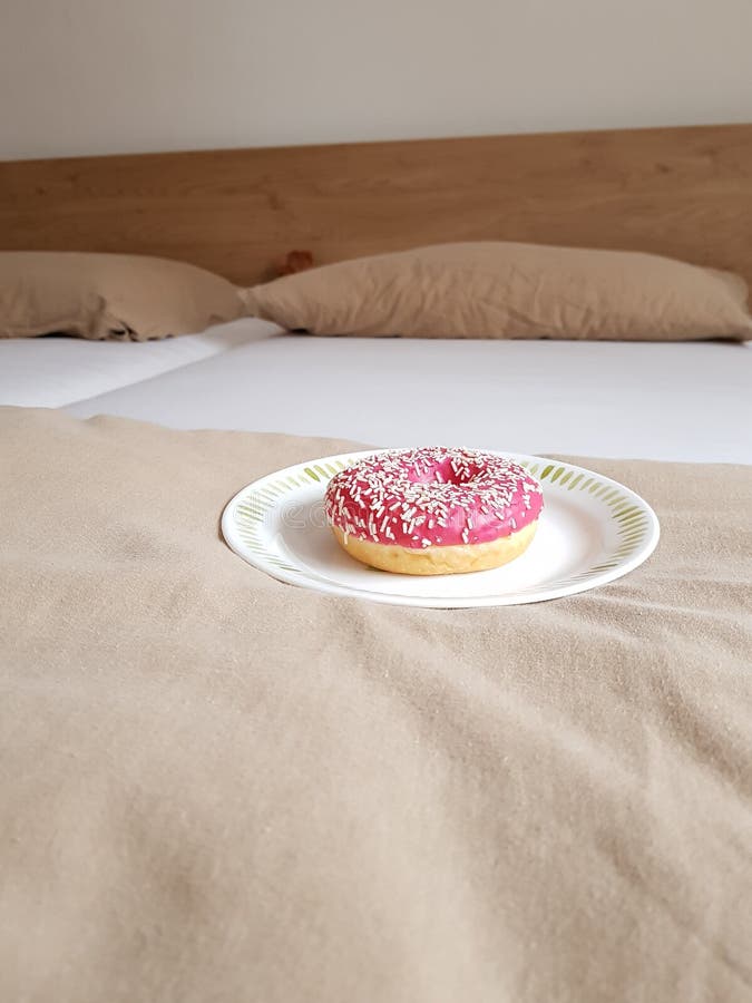 Donut in bed stock photo. Image of sitting, enjoying - 138336774